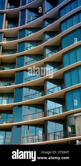 Beautiful facade of multi-storied apartment block with mirror windows ...