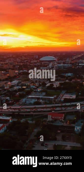 Orange bright burning skies at sunset above the vast urban scenery ...