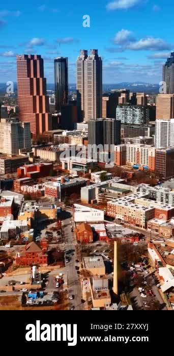 Flight above the low-rise and high-rise architecture of American city ...
