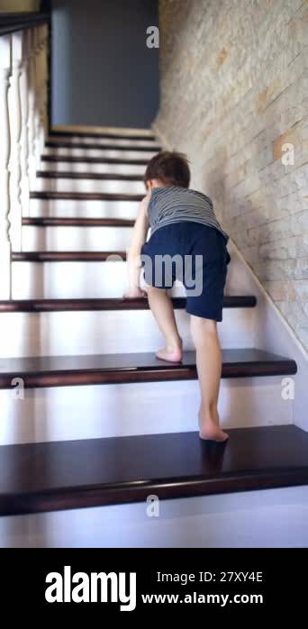 Following a toddler boy crawling up the stairs on all four. Cute ...