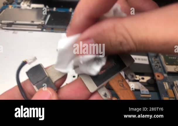 Technician cleans microprocessor heatsink from thermal paste. Computer ...