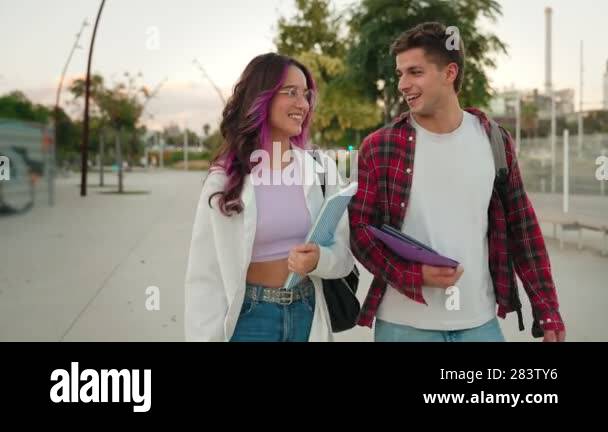 Student friends talking on university campus going to the Uni lecture ...
