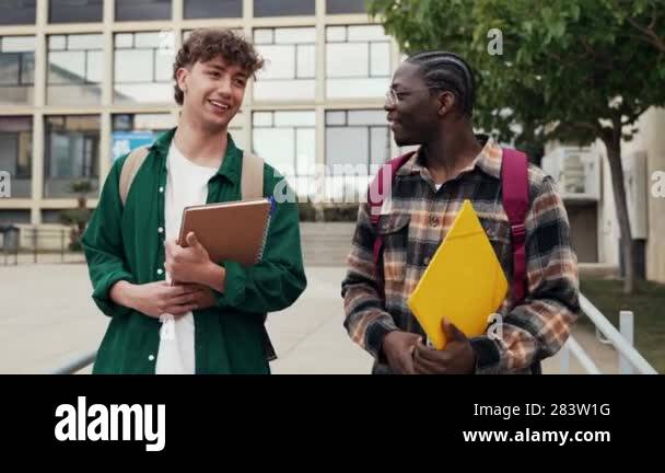 African American Student with friend going home walking after classes ...