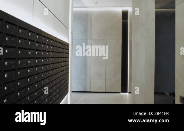 This stylish hallway showcases modern mailboxes paired with sleek ...