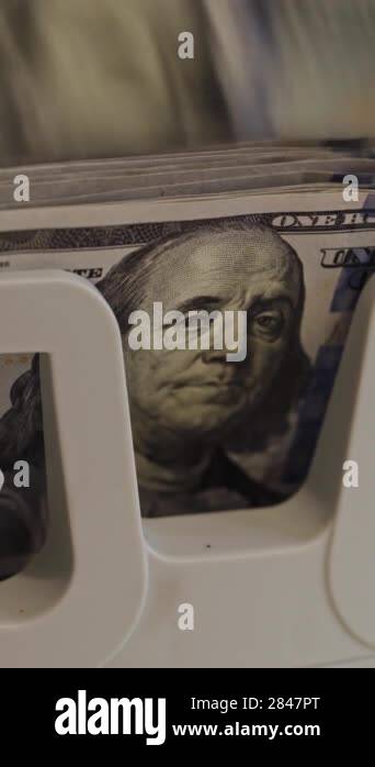 Employees are sorting stacks of money inside a cash handling facility ...