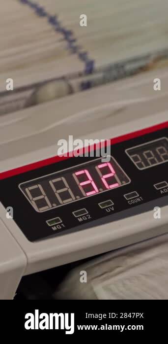 A currency counting machine shows a total of 83.2 on its digital ...