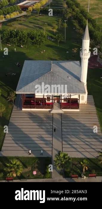 Aerial view of mosque in the park, people are praying in the mosque ...