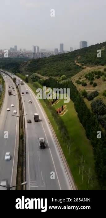 Drone aerial view of road with forest and trees along the road with few ...