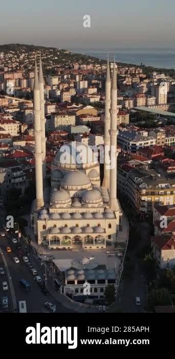 Aerial view of the mosque between the building, people pray in the ...