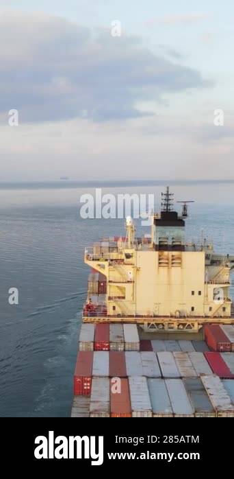 Aerial front view container cargo ship carrier container from the commercial port for business ...