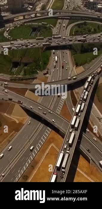 Timelapse of a drone flying in city traffic, an aerial view of cars ...