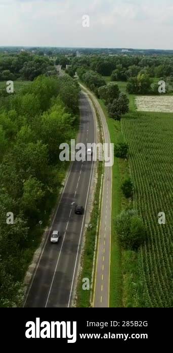 An aerial view of the two sides of a highway surrounded by trees and ...