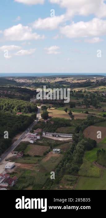 Aerial view of asphalt road with rural area on both sides, village with ...