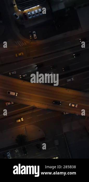 Aerial view evening night cars traffic, vehicles passing over underpass ...