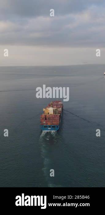 Aerial front view container cargo ship carrier container from the commercial port for business ...