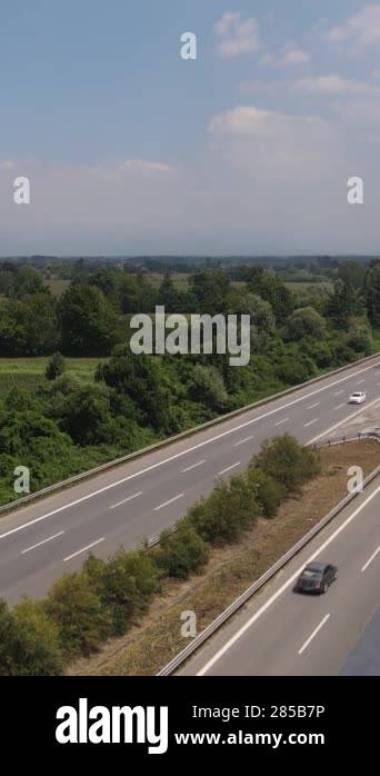 Aerial view of asphalt road with the rural area on both sides, the ...
