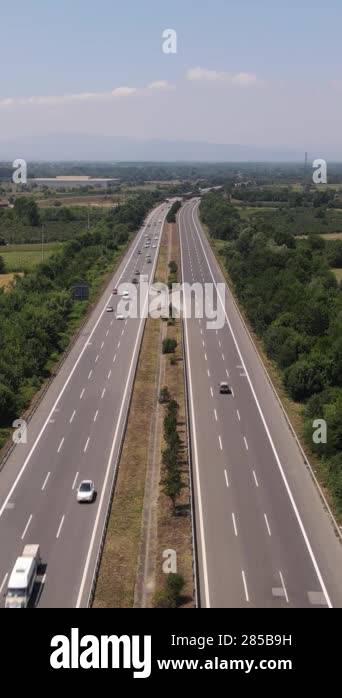 Aerial view of asphalt road with the rural area on both sides, the ...
