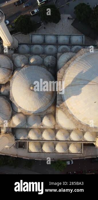 Aerial view of the mosque between the buildings, people are praying in ...