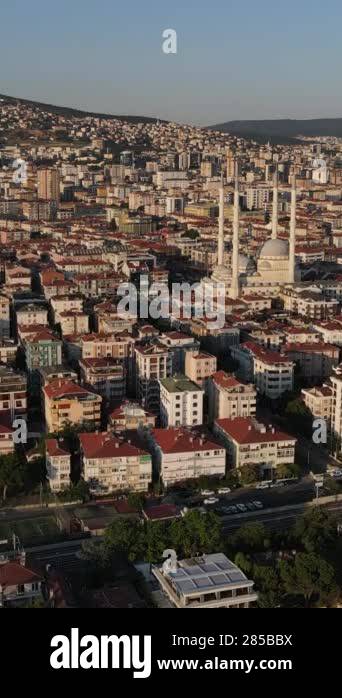 Aerial view of the mosque between the buildings, people are praying in ...