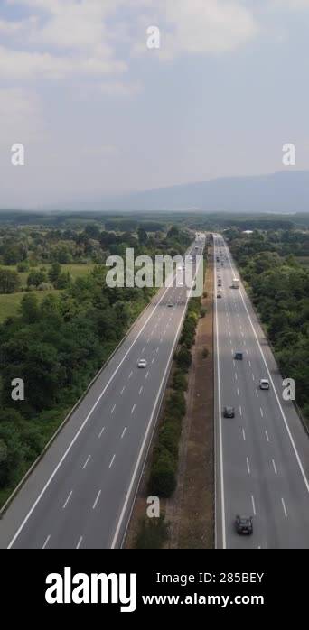 Aerial view of asphalt road with the rural area on both sides, the ...