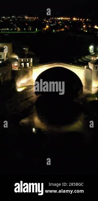 Night illuminated drone view of the historical Mostar bridge ...