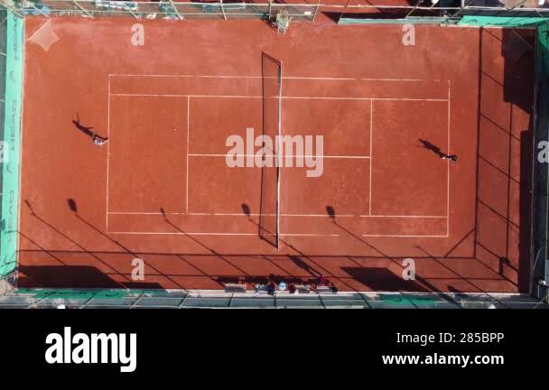 Overhead shot of two men playing tennis on the court, young people ...