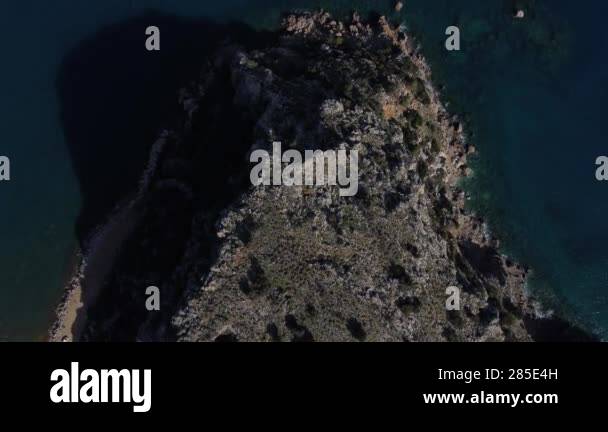 Overhead view rising above the island on the mediterranean coast ...