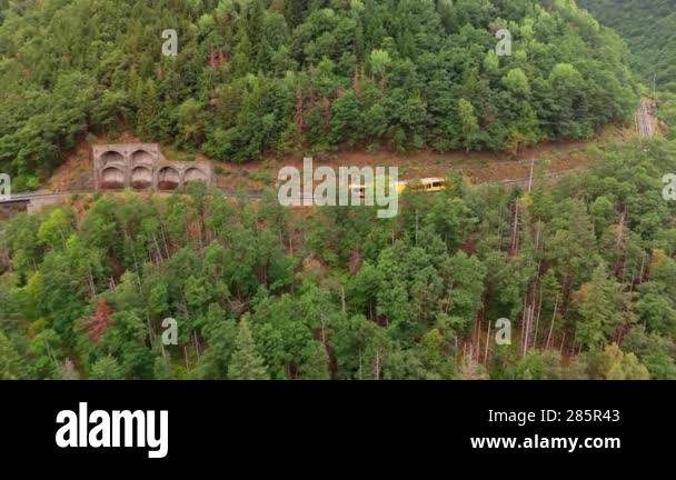 Aerial view of the little yellow train in picturesque Pyrenees ...
