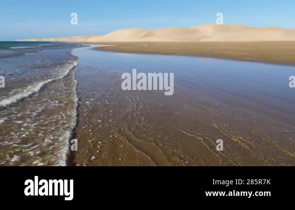 Beautiful serene sand dunes and beach. Where the Sahara desert meets ...