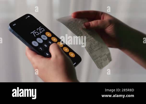 Woman paying bills online using smartphone at home. Bill paying concept ...