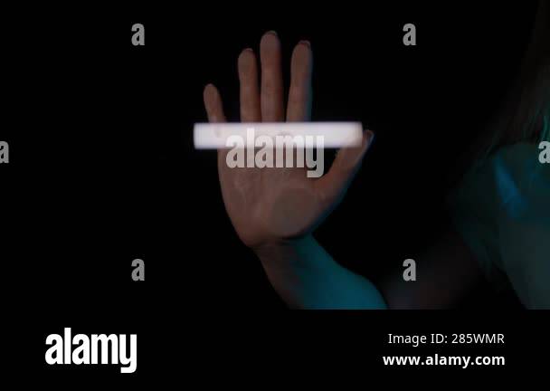 Computer technology and cyberspace security. Woman touches glass screen panel, open palm print ...