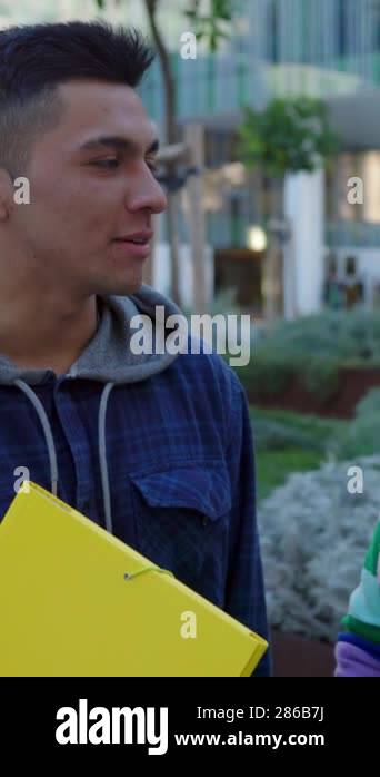 Vertical HD video of diverse student friends hanging out while standing ...