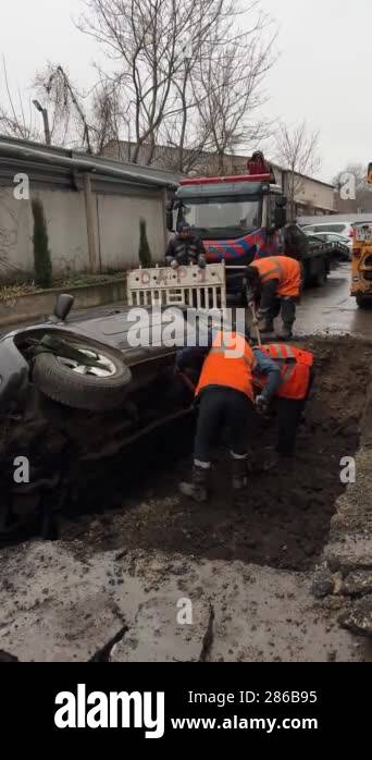 Accident on the road: a passenger car has fallen through the asphalt ...