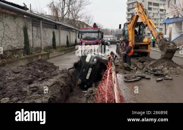 Accident on the road: a passenger car has fallen through the asphalt ...