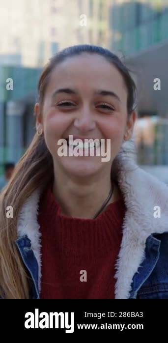 Vertical video. Portrait of young caucasian student girl smile at ...