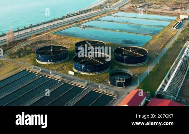 Aerial view of modern sewage wastewater treatment plant with circular tanks and sedimentation ...