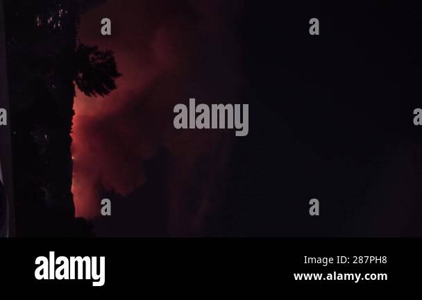 Vertical. A haunting and dramatic scene of a wildfire lighting up the ...