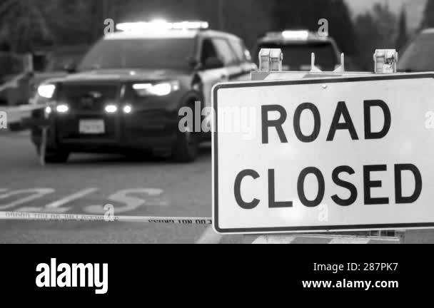 Black and White. A detailed scene of a road closure enforced by law ...