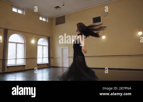 Graceful ballerina dancing elements of classical ballet in the dance ...