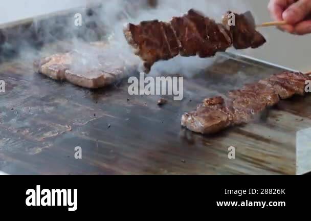 Chef grilling skewered Japan Wagyu beef or meat with a fire blowtorch ...
