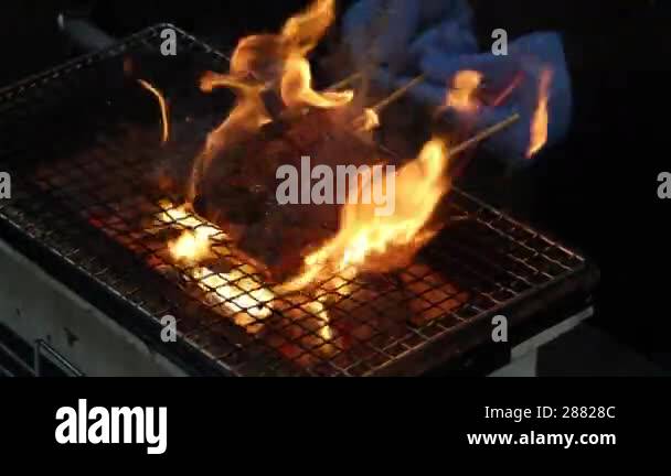 Chef grilling skewered Japan Wagyu beef or meat with a fire blowtorch ...