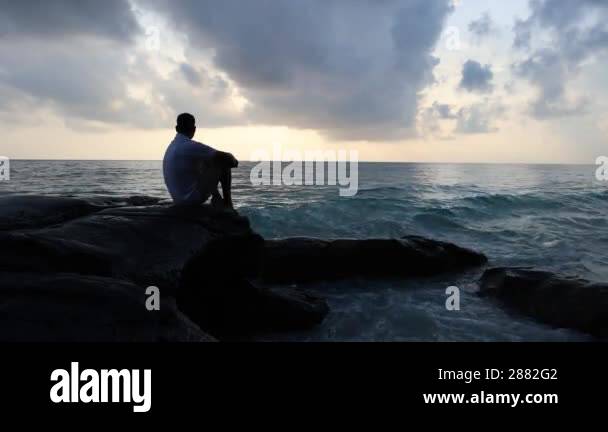 isolated man escaping sudden sea wave under dramatic dawn sky Stock ...