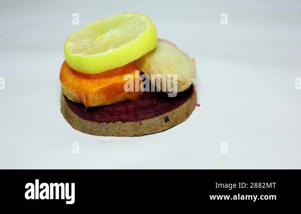 slice of fresh raw turmeric, beetroot, lemon and ginger in studio on ...