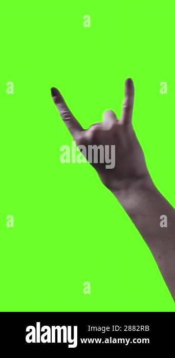 Woman with Rock and Roll Devil Horns Gesture Against a Green Screen ...