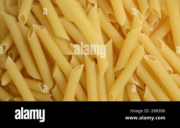 Raw Penne Rigate Pasta, Unspun and Sprinkled on Top. Feather Shaped ...