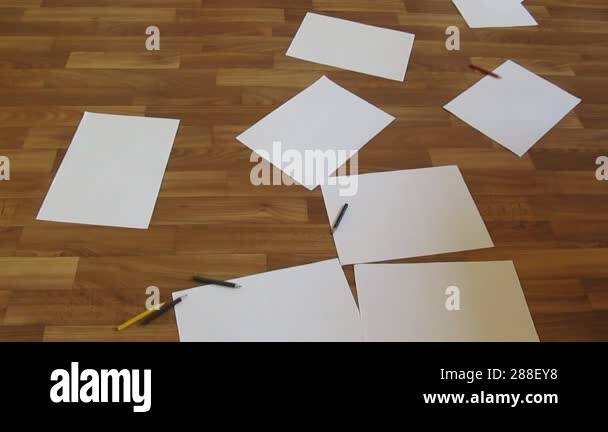 Multicolored pencils, pens and markers drop on the brown floor that ...