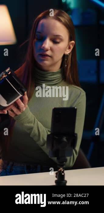 Vertical video Gen Z tech expert filming sponsored content, unboxing ...