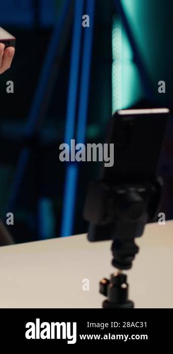 Vertical video Gen Z girl in apartment studio using mobile phone to ...