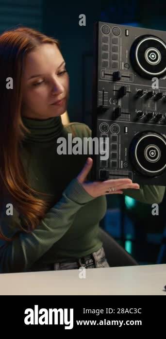 Vertical video Gen Z artist mixing on DJ turntables, doing music ...