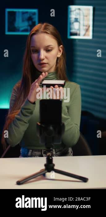 Vertical video Young content creator using cellphone to film room tour ...